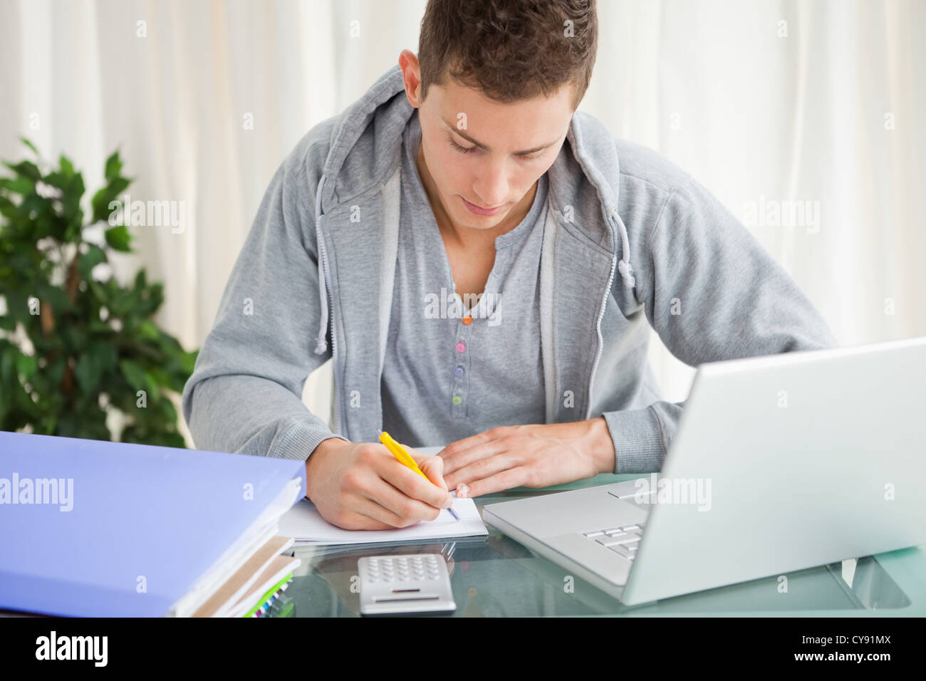 Student doing his homework Stock Photo - Alamy