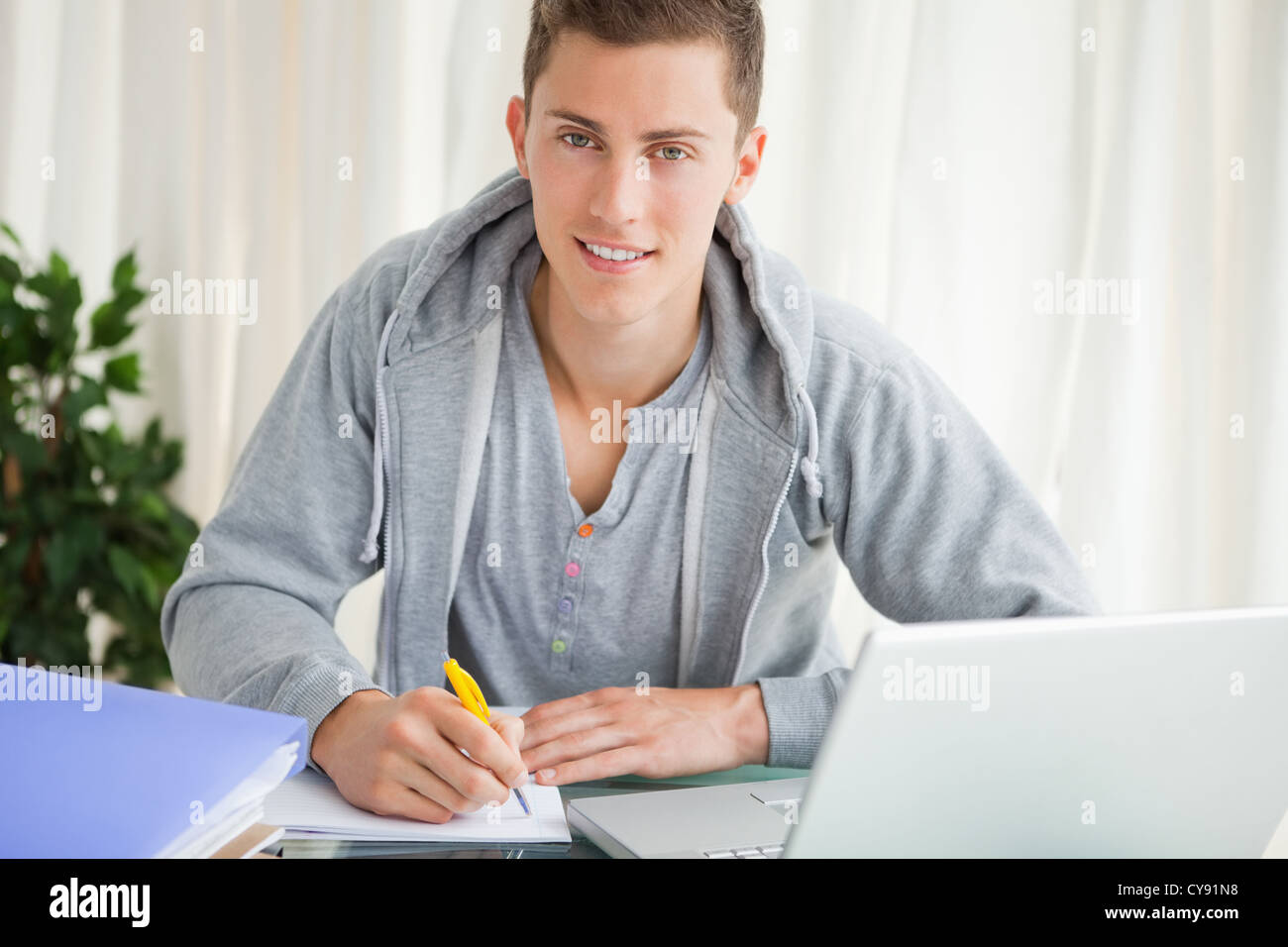 Portrait of a student doing his homework Stock Photo - Alamy