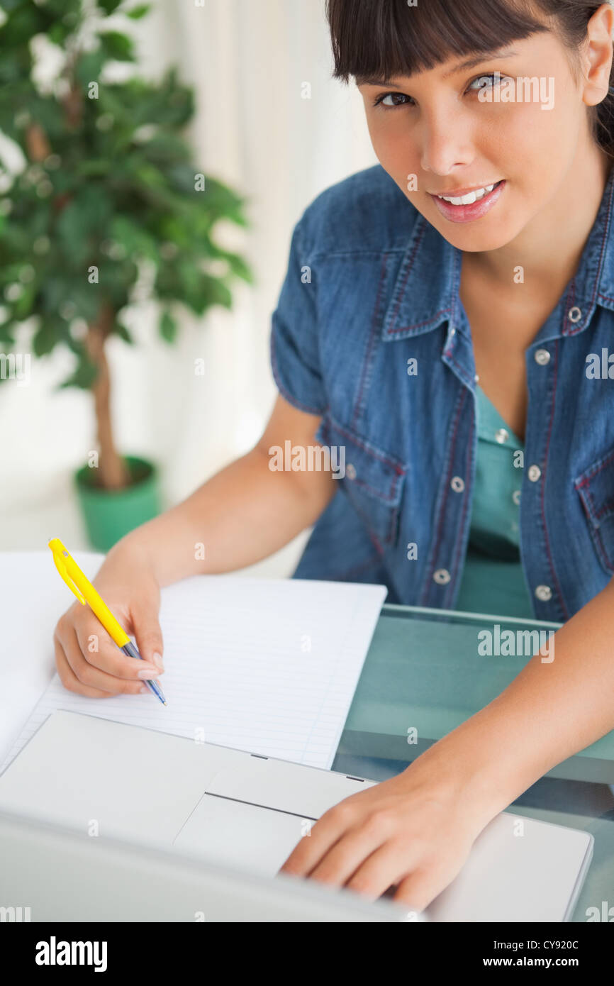 Portrait of a cute smiling student doing her homework Stock Photo - Alamy