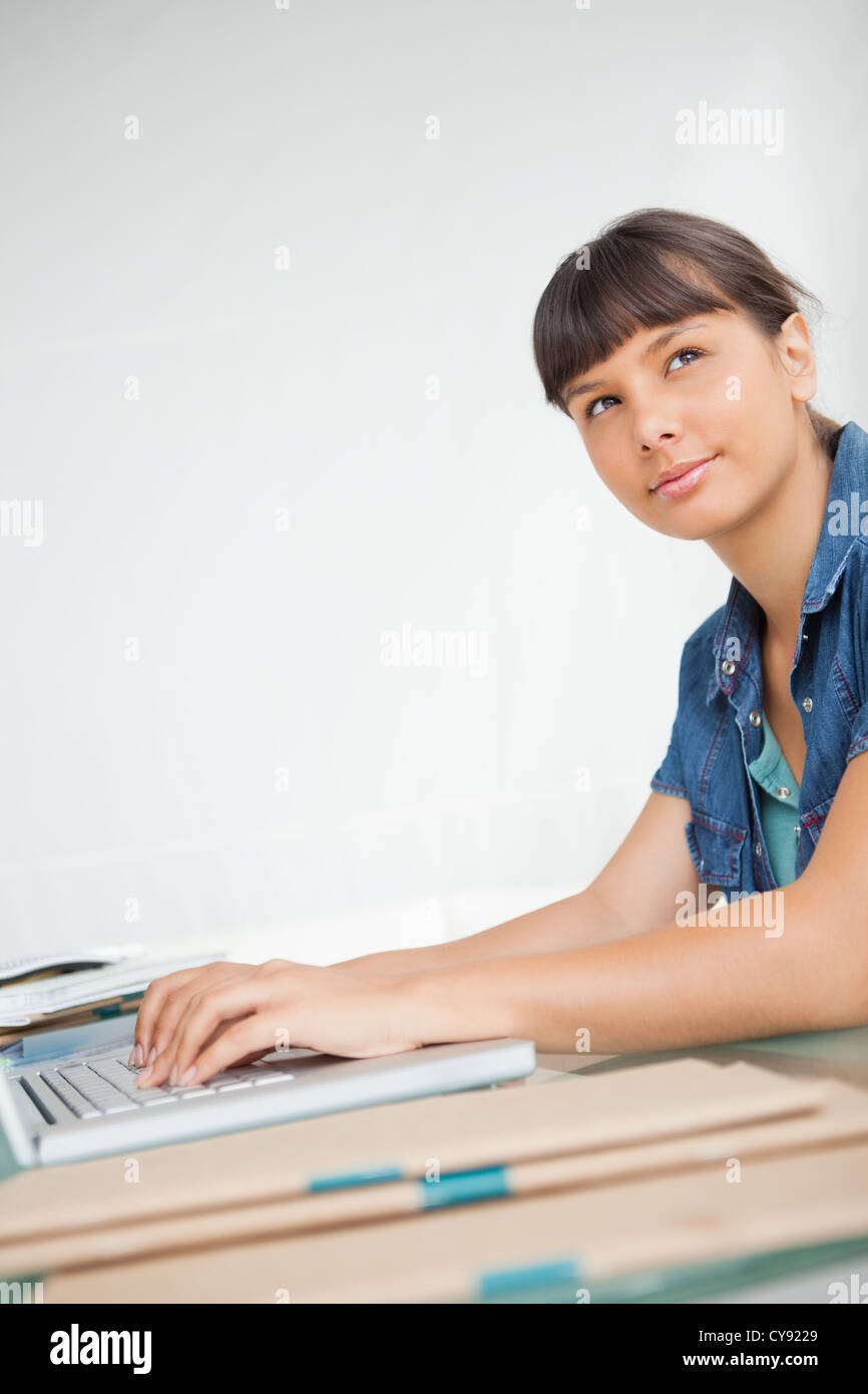 Pretty student doing her homework Stock Photo - Alamy