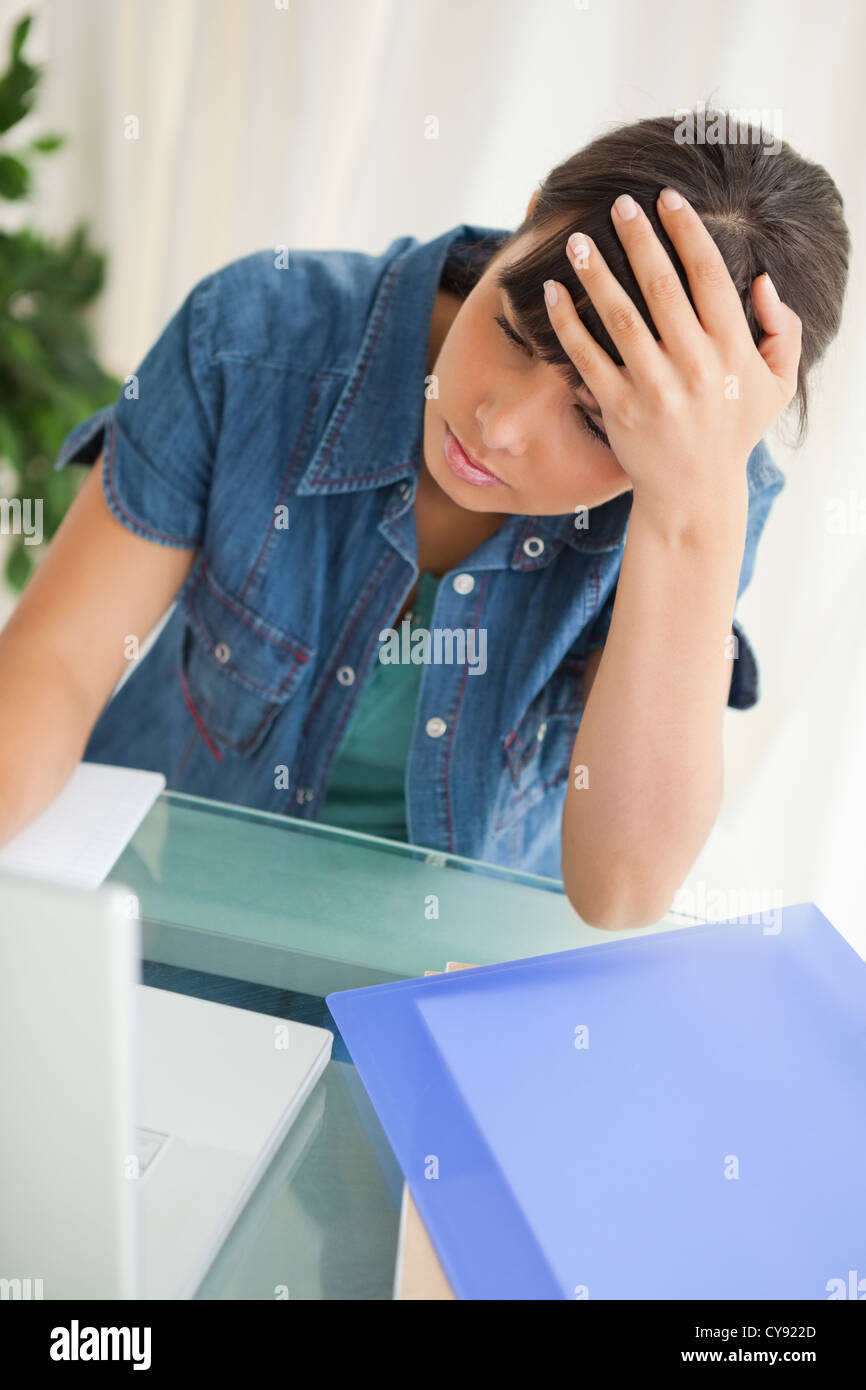 Student with a headache while doing her homework Stock Photo - Alamy