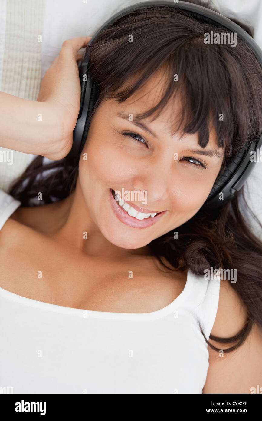 Portrait of a smiling student listening to music Stock Photo - Alamy