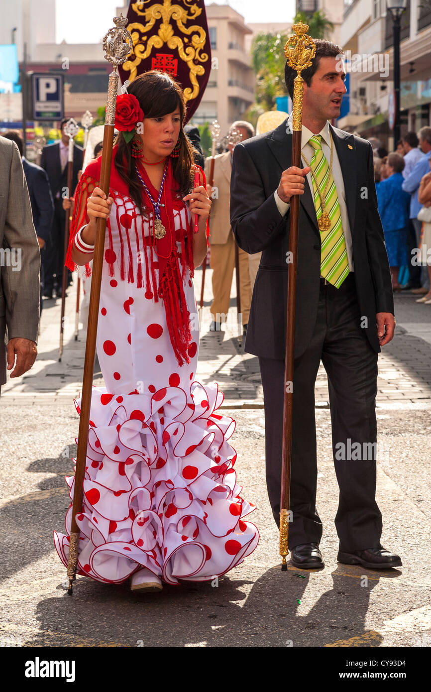 A man and woman follow a Religious Procession in Fuengirola. Spain ...