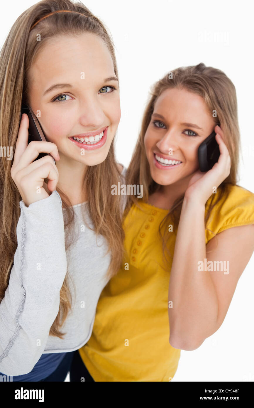 Close-up of two students smiling on the phone Stock Photo - Alamy