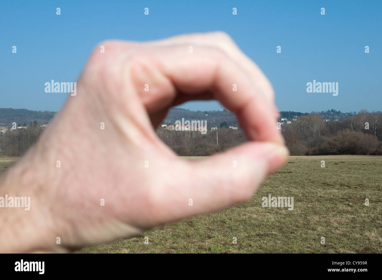 hand forming a circle to see houses in countryside Stock Photo - Alamy