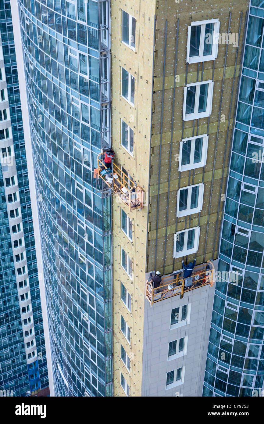 Construction platform with installers on the facade of high-rise ...