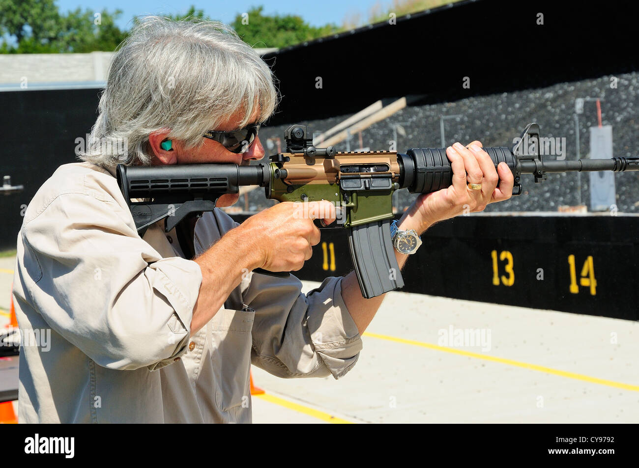 Gunman test firing automatic rifle at the FBI shooting range in Chicago ...