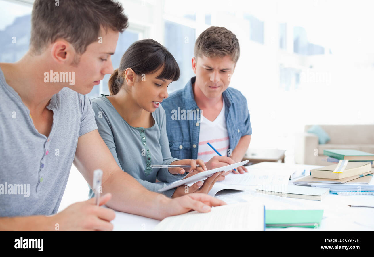 Side view of three students studying Stock Photo - Alamy