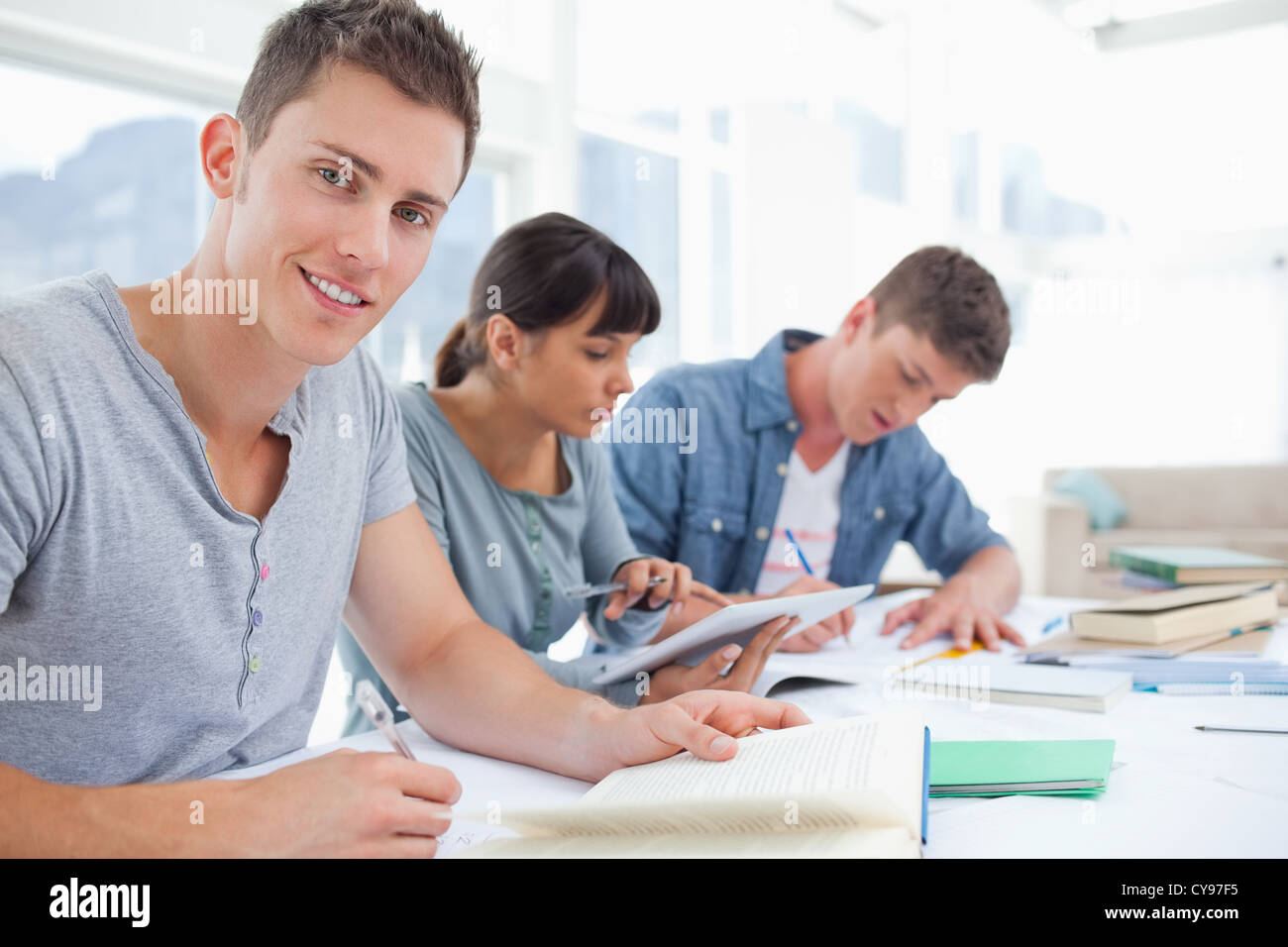 Side view of a group of students as one student looks at the camera ...