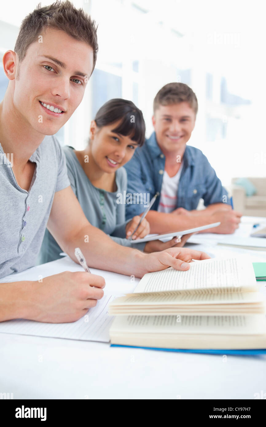A close up of three studying friends as they look into the camera Stock ...