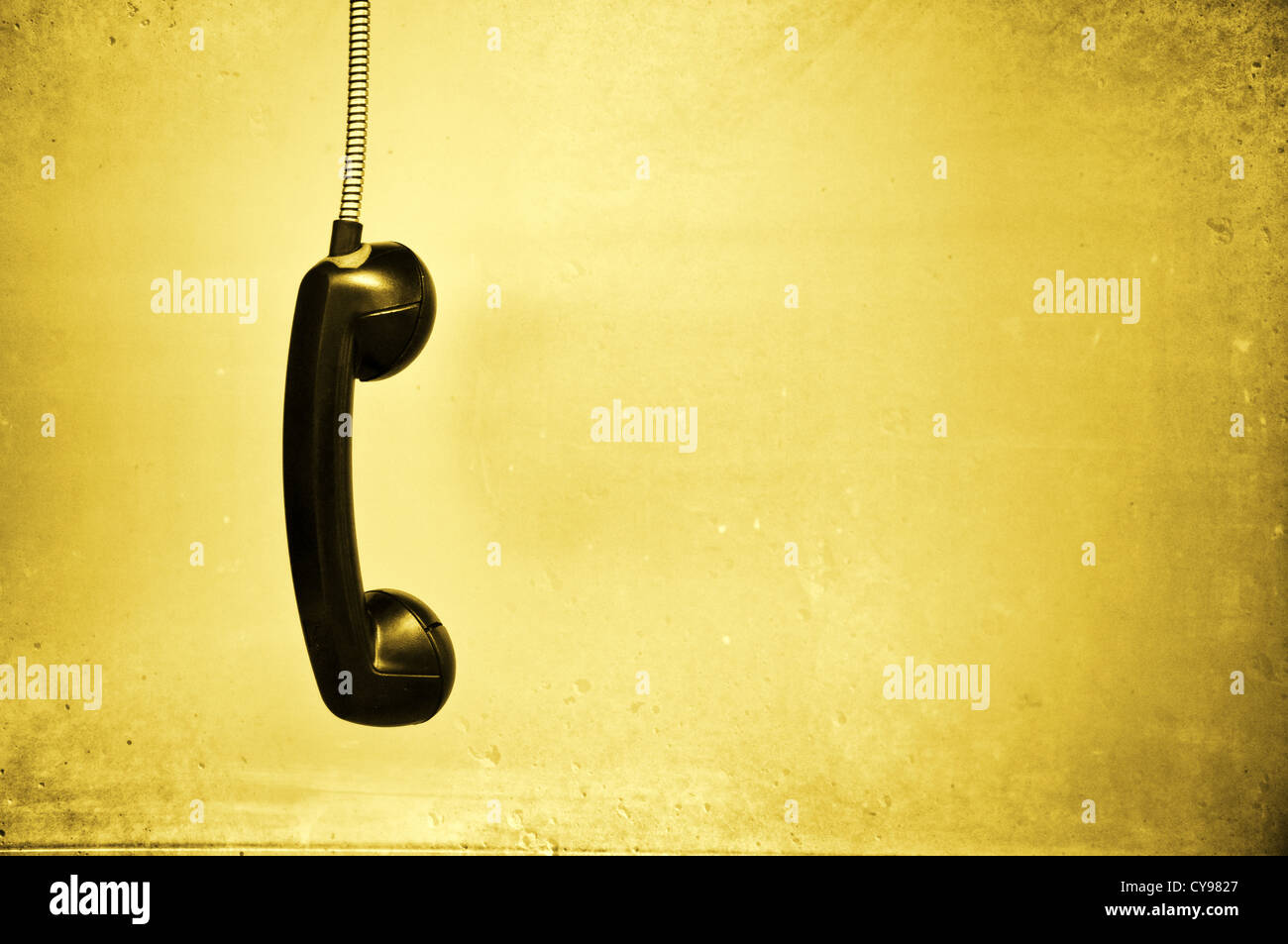 Hanging vintage phone receiver over a grunge background Stock Photo - Alamy