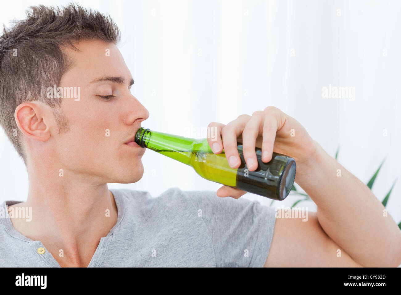 A handsome man drinking some beer Stock Photo - Alamy