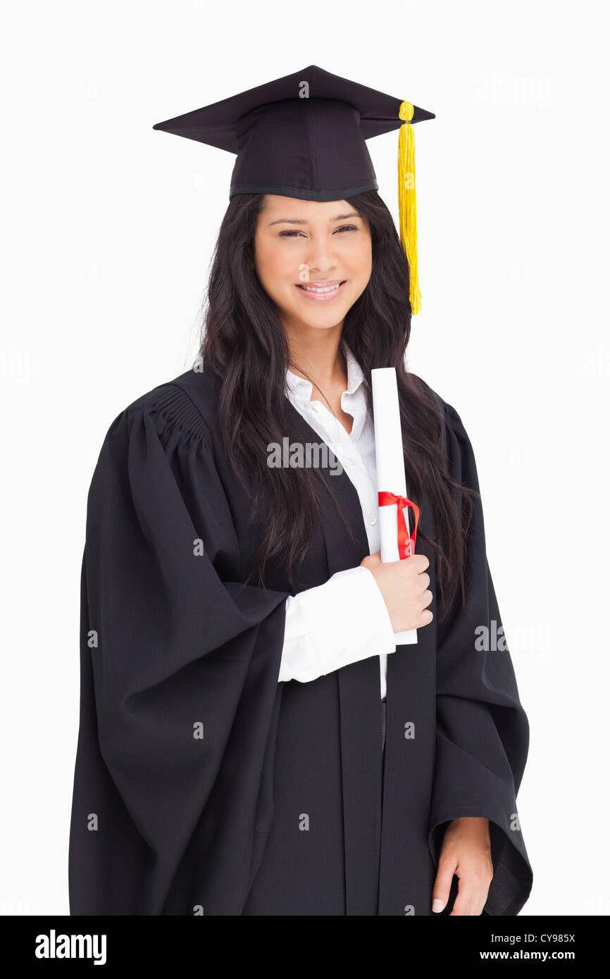 A smiling woman holding her degree as she has graduated from university ...