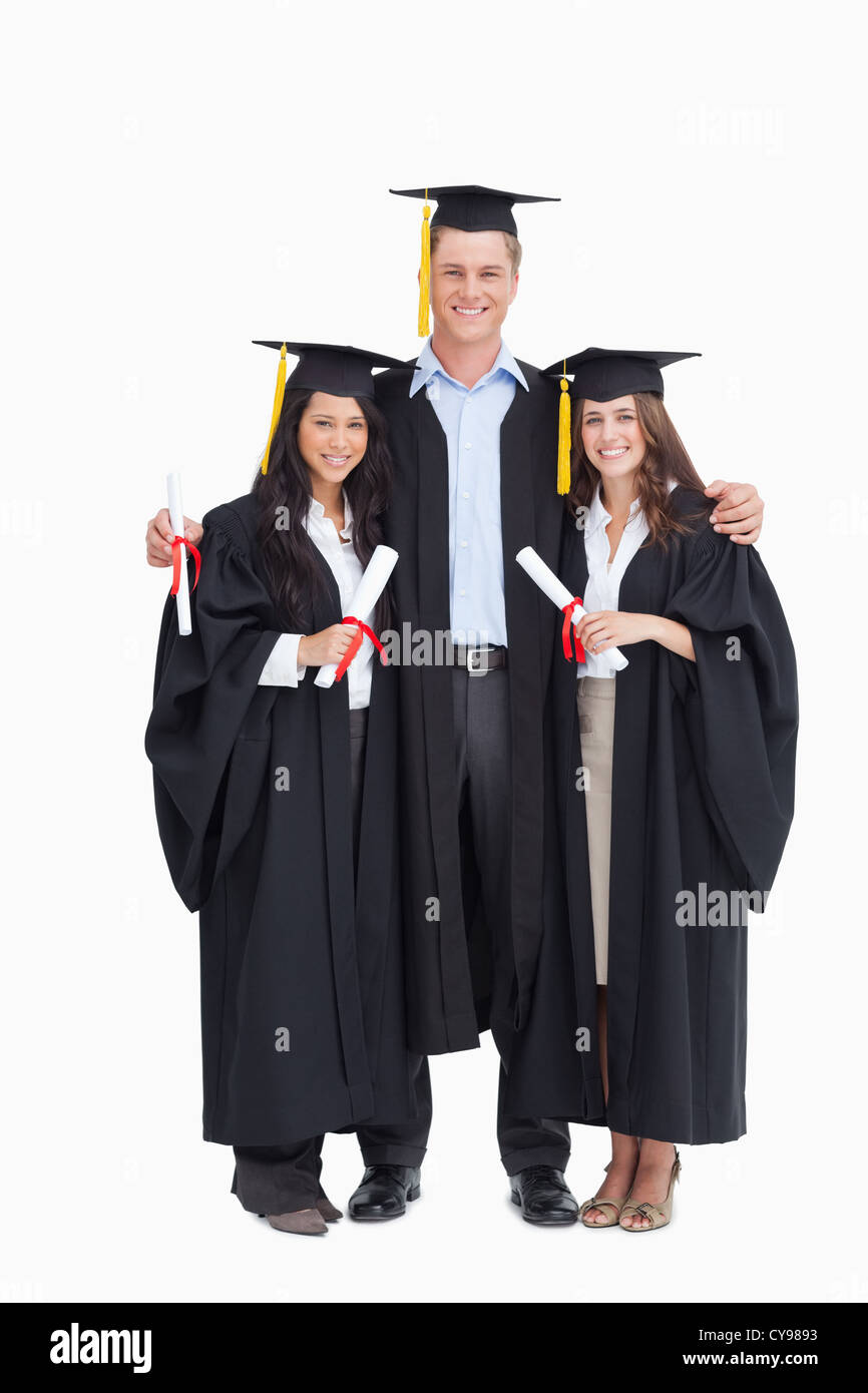 Full length of three friends graduate from college together Stock Photo ...