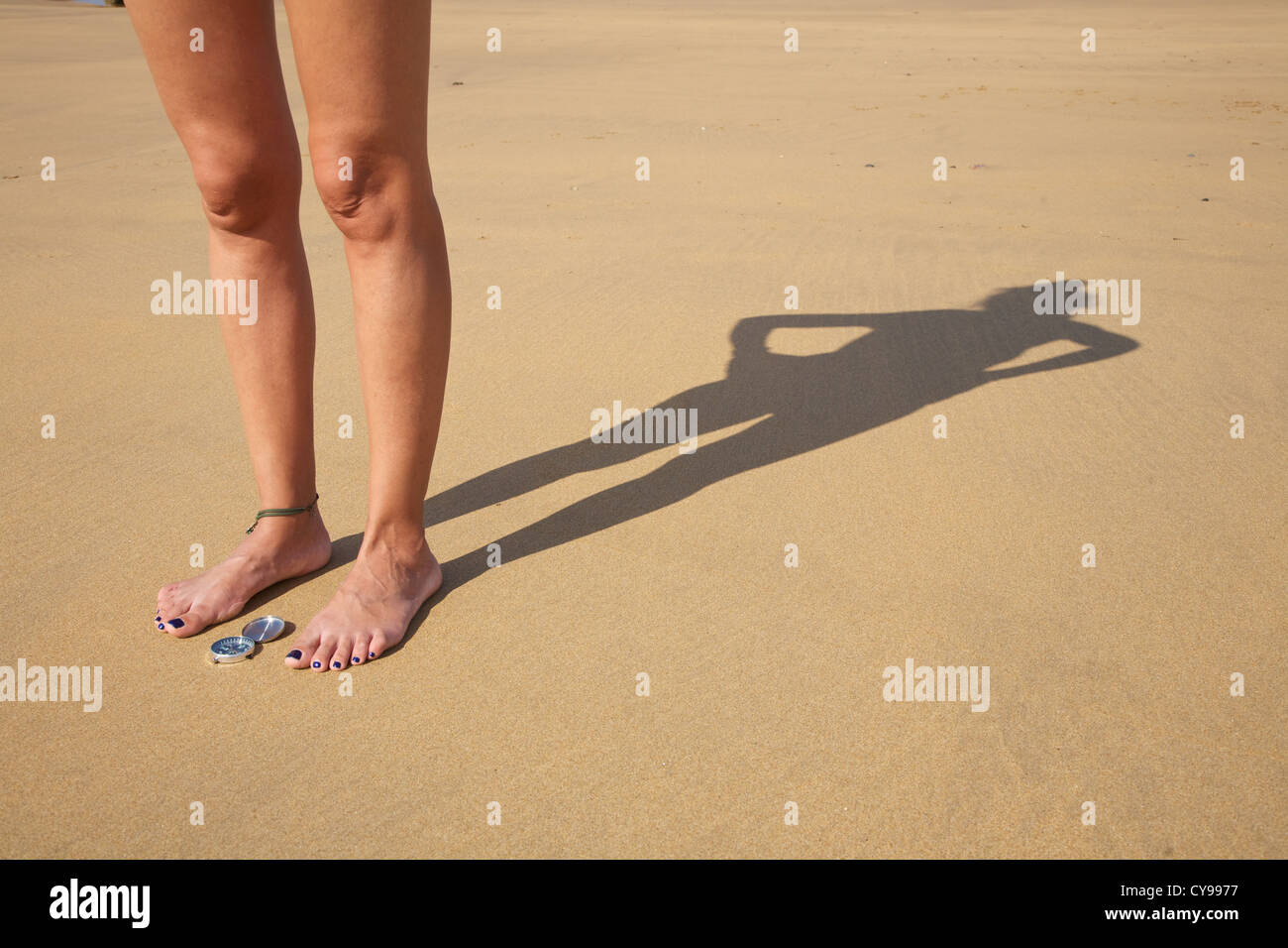 woman legs and shade with compass in a beach Stock Photo - Alamy