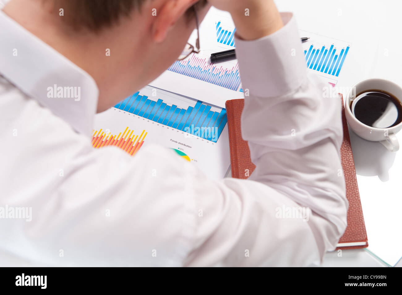 Stressed executive at workplace holding his head. Rear view Stock Photo ...