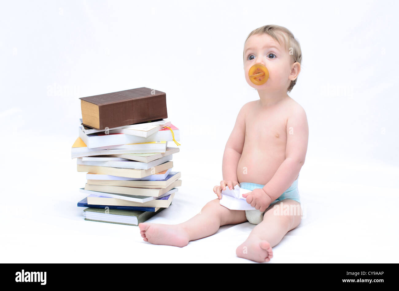 a cute baby near a stack of books Stock Photo - Alamy