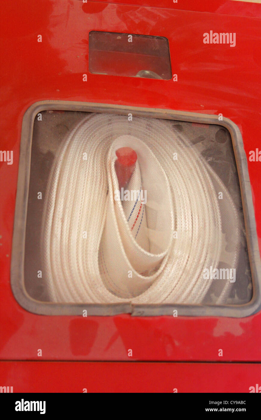 Red fire water lines in front of a building Stock Photo - Alamy