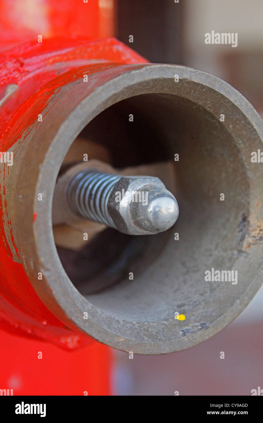 Red fire water lines in front of a building Stock Photo - Alamy