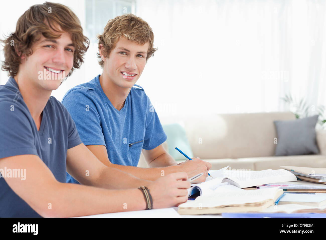 Side view of two students looking into the camera and smiling Stock ...