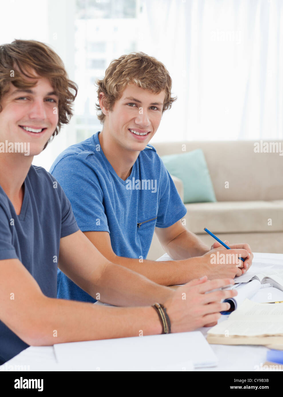 A close up shot of two smiling students as they both look at the camera ...