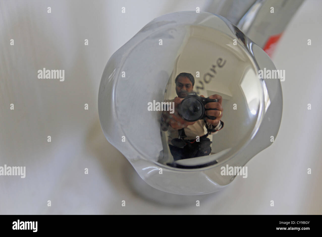 Reflection of photographer in Modern faucet with stainless steel ...