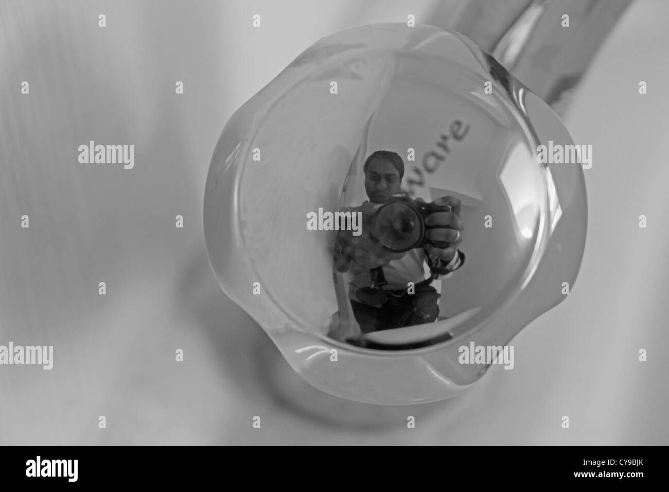 Reflection of photographer in Modern faucet with stainless steel ...