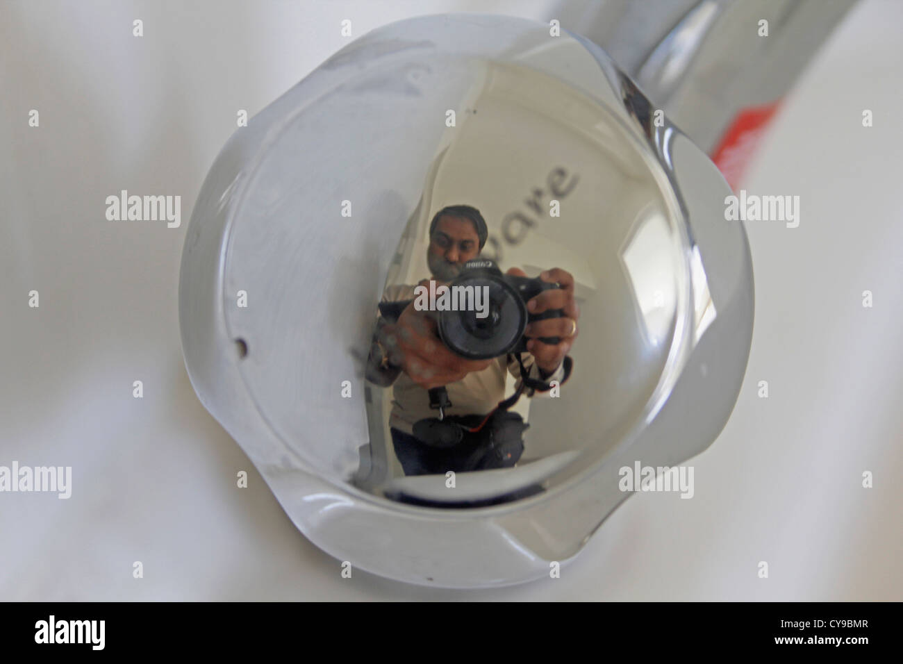 Reflection of photographer in Modern faucet with stainless steel ...