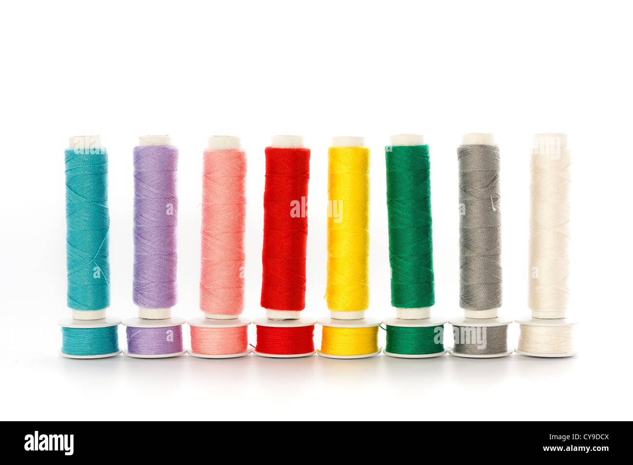 Multicolored sewing threads in a row isolated on white Stock Photo - Alamy