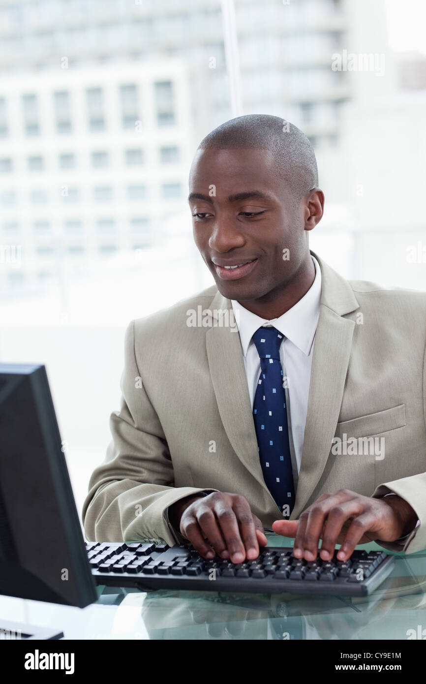 Portrait of a happy office worker using a computer Stock Photo - Alamy