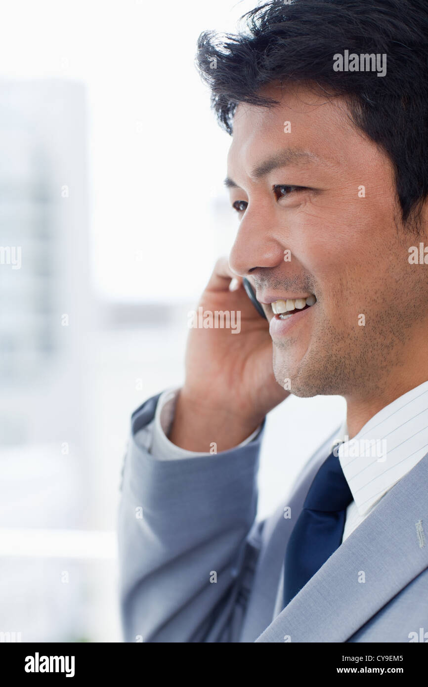Portrait of a smiling office worker on the phone Stock Photo - Alamy