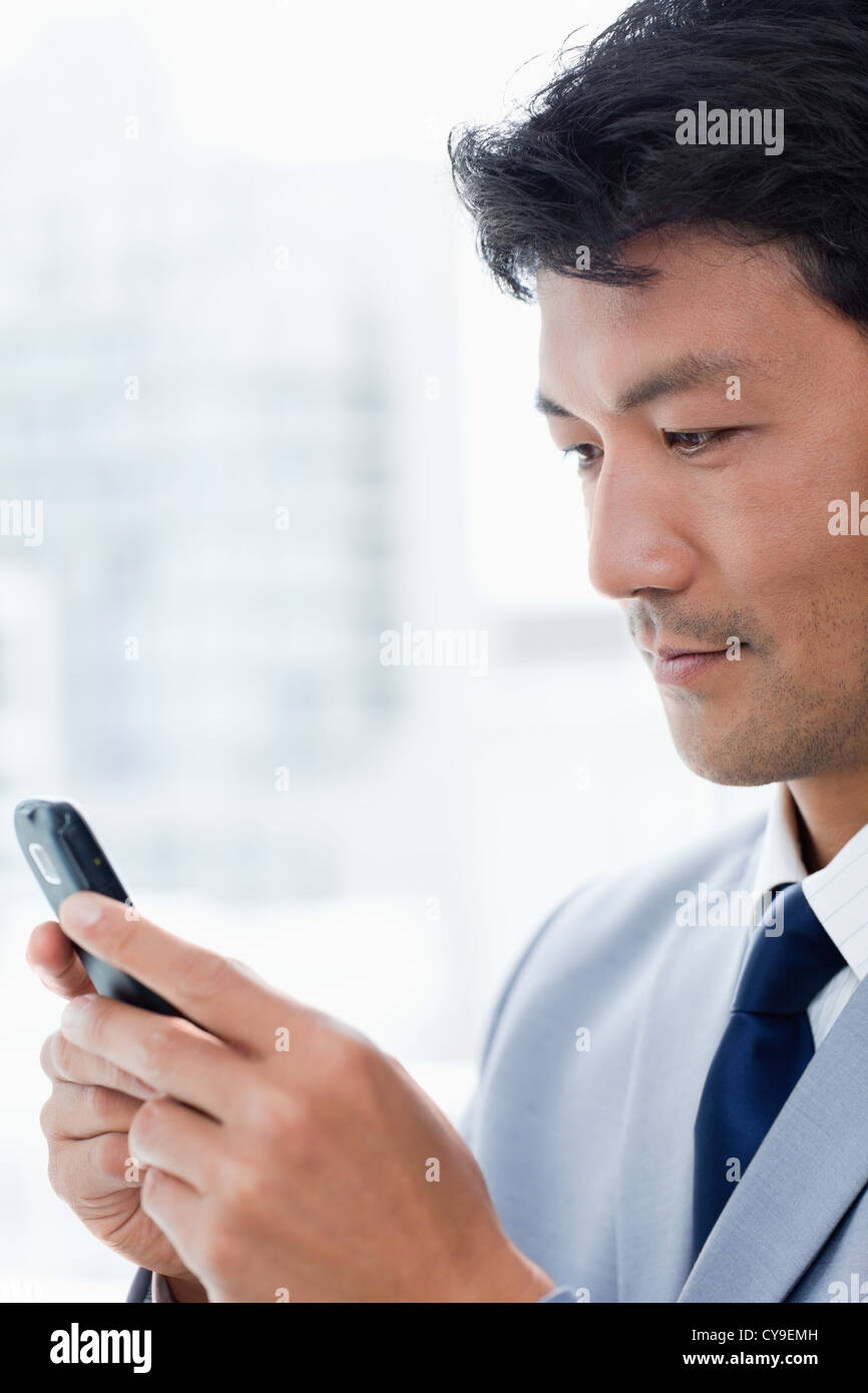 Portrait of an office worker using his mobile phone Stock Photo - Alamy