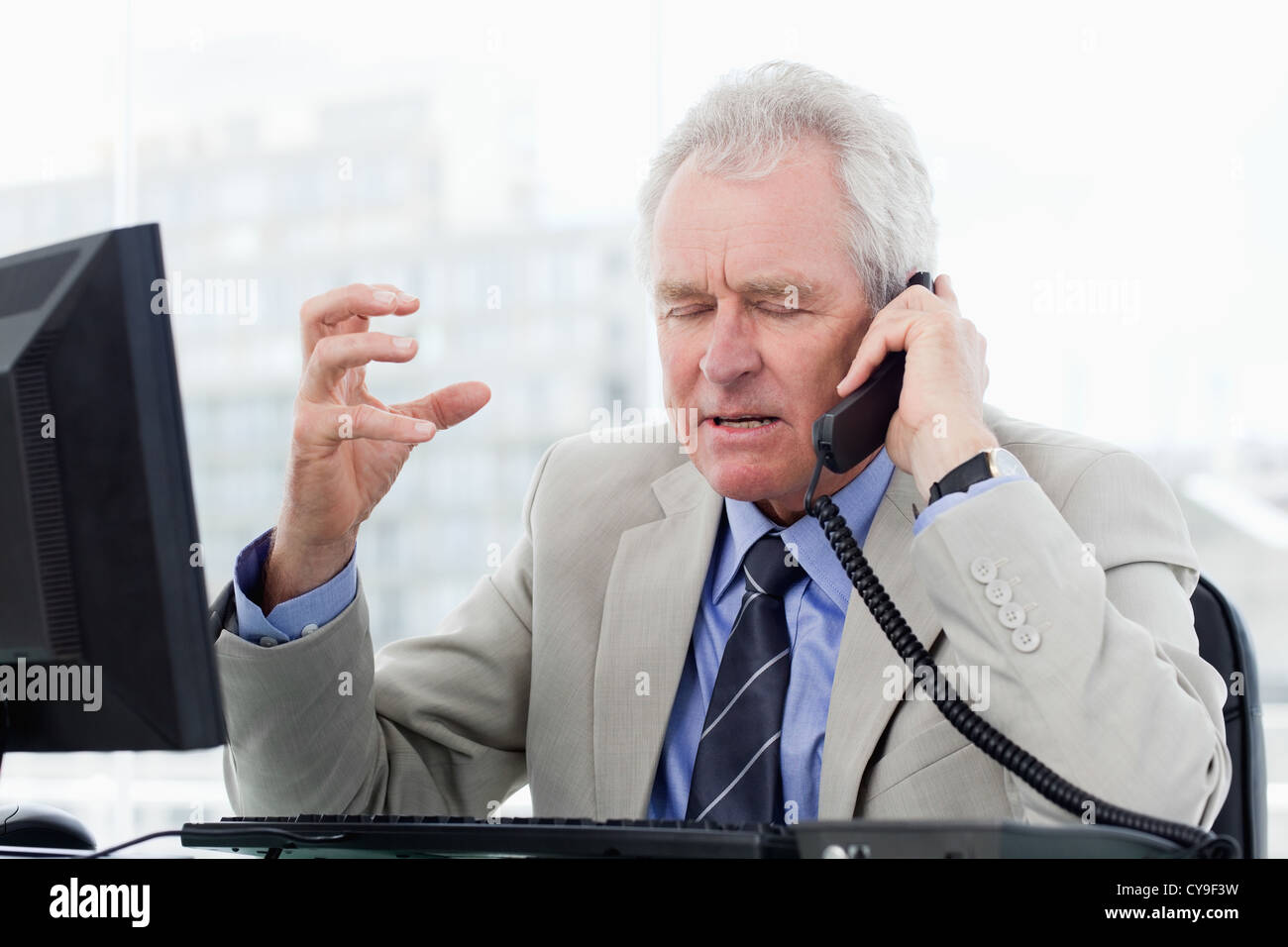 Irritated senior manager on the phone Stock Photo - Alamy