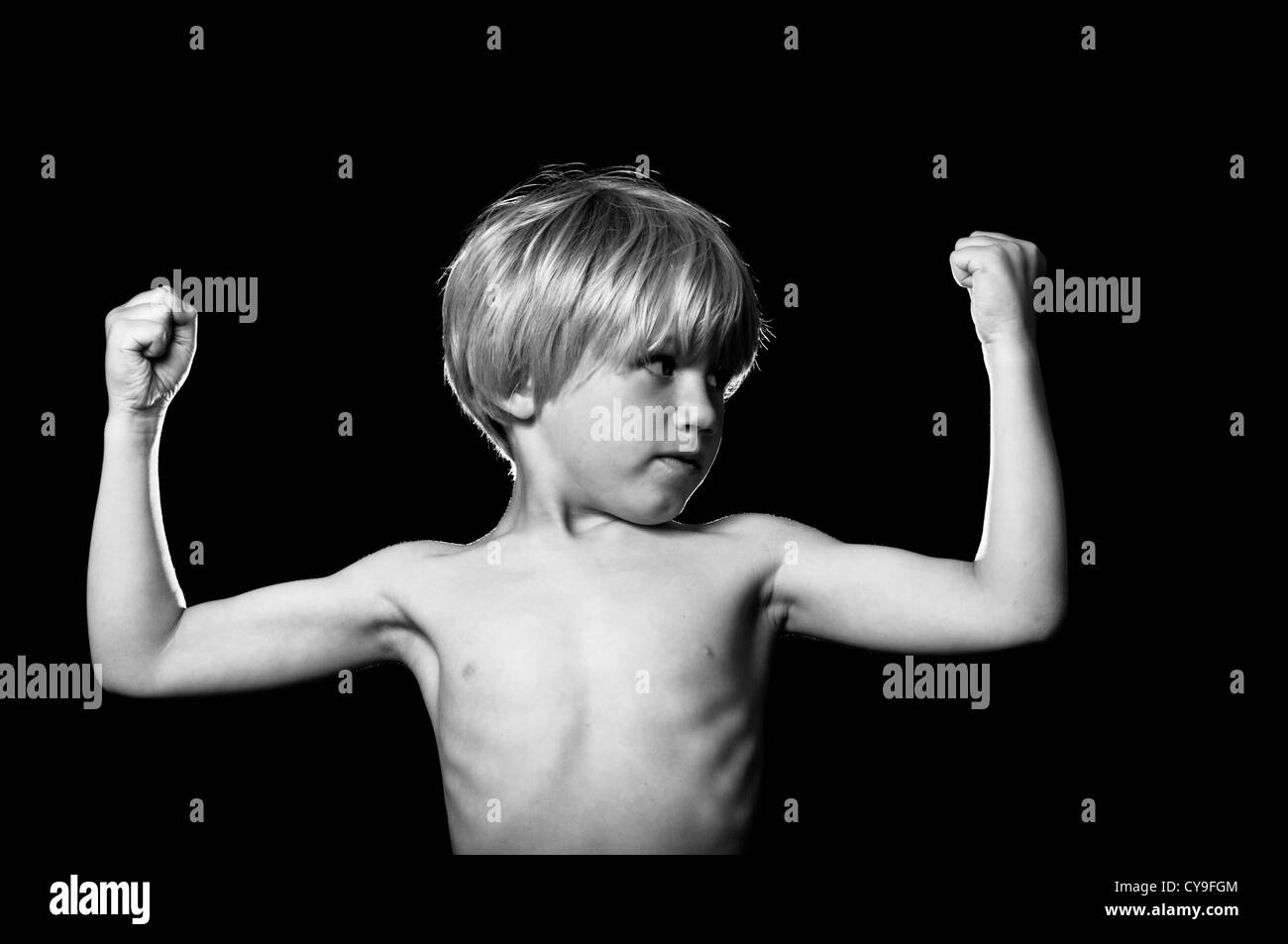 Little boy flexing muscles Stock Photo - Alamy