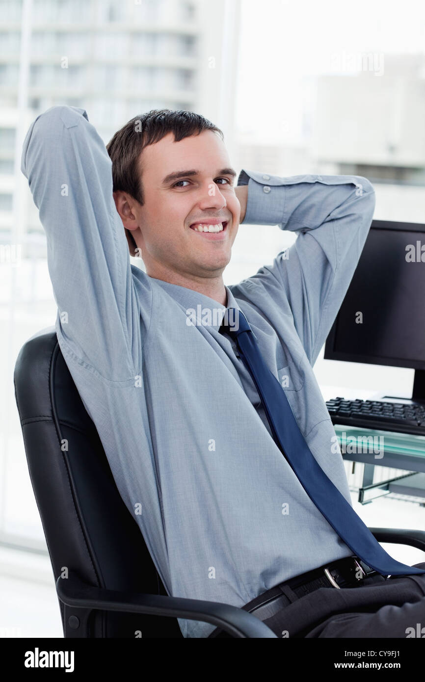 Portrait of a smiling manager relaxing Stock Photo - Alamy