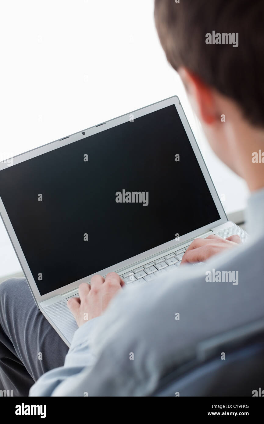 Back view of a businessman typing on a laptop Stock Photo - Alamy