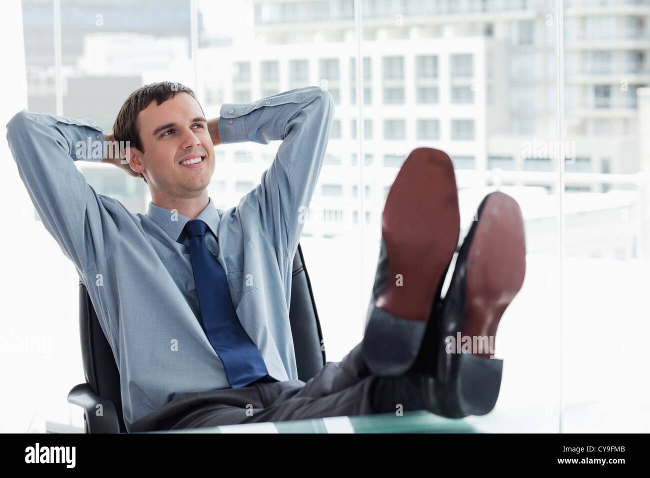 Happy manager relaxing Stock Photo - Alamy