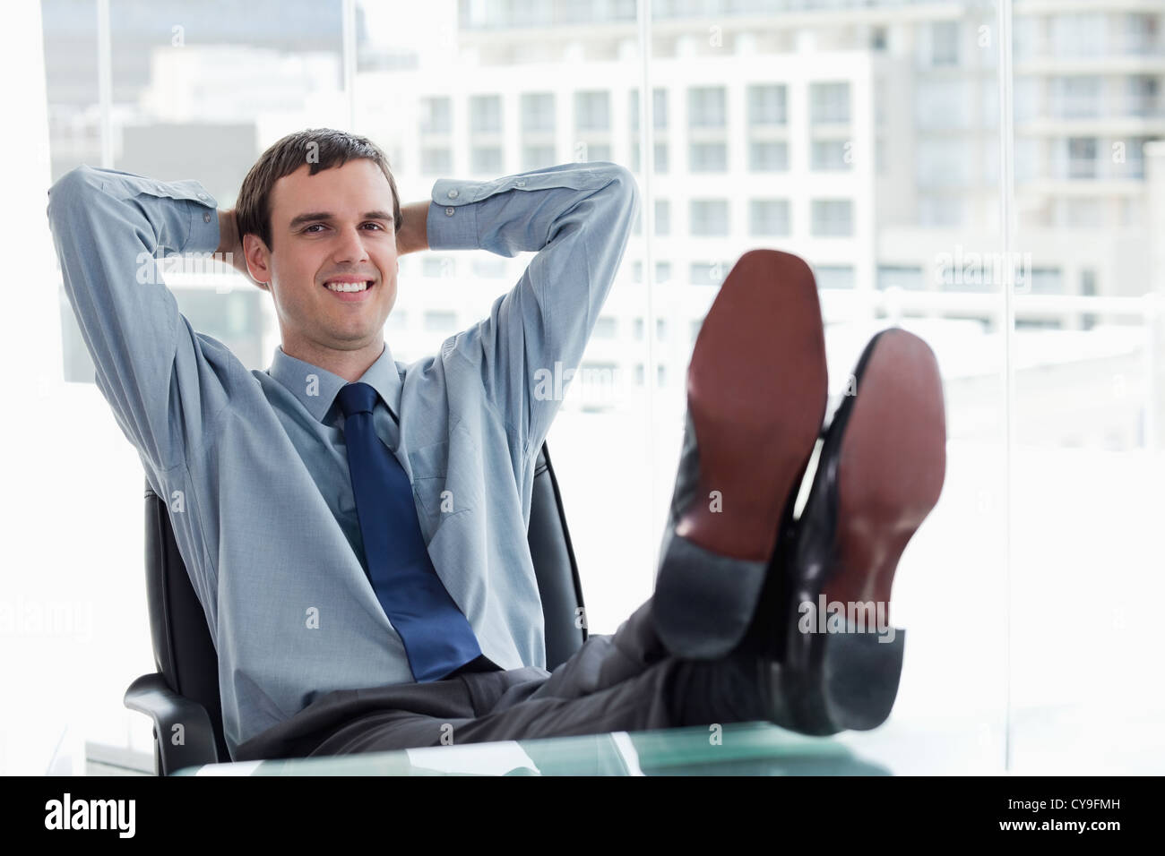 Smiling manager relaxing Stock Photo - Alamy
