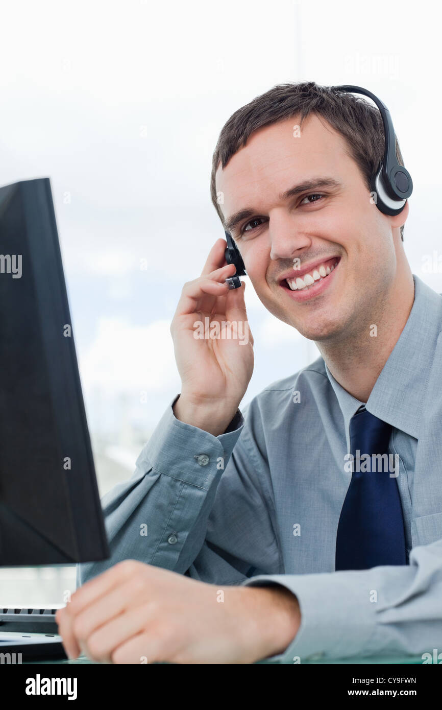 Portrait of an office worker using a headset Stock Photo - Alamy