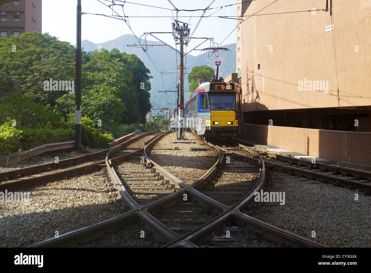 Light rail train approaches Siu Hong Station near Yuen Long, Hong Kong ...