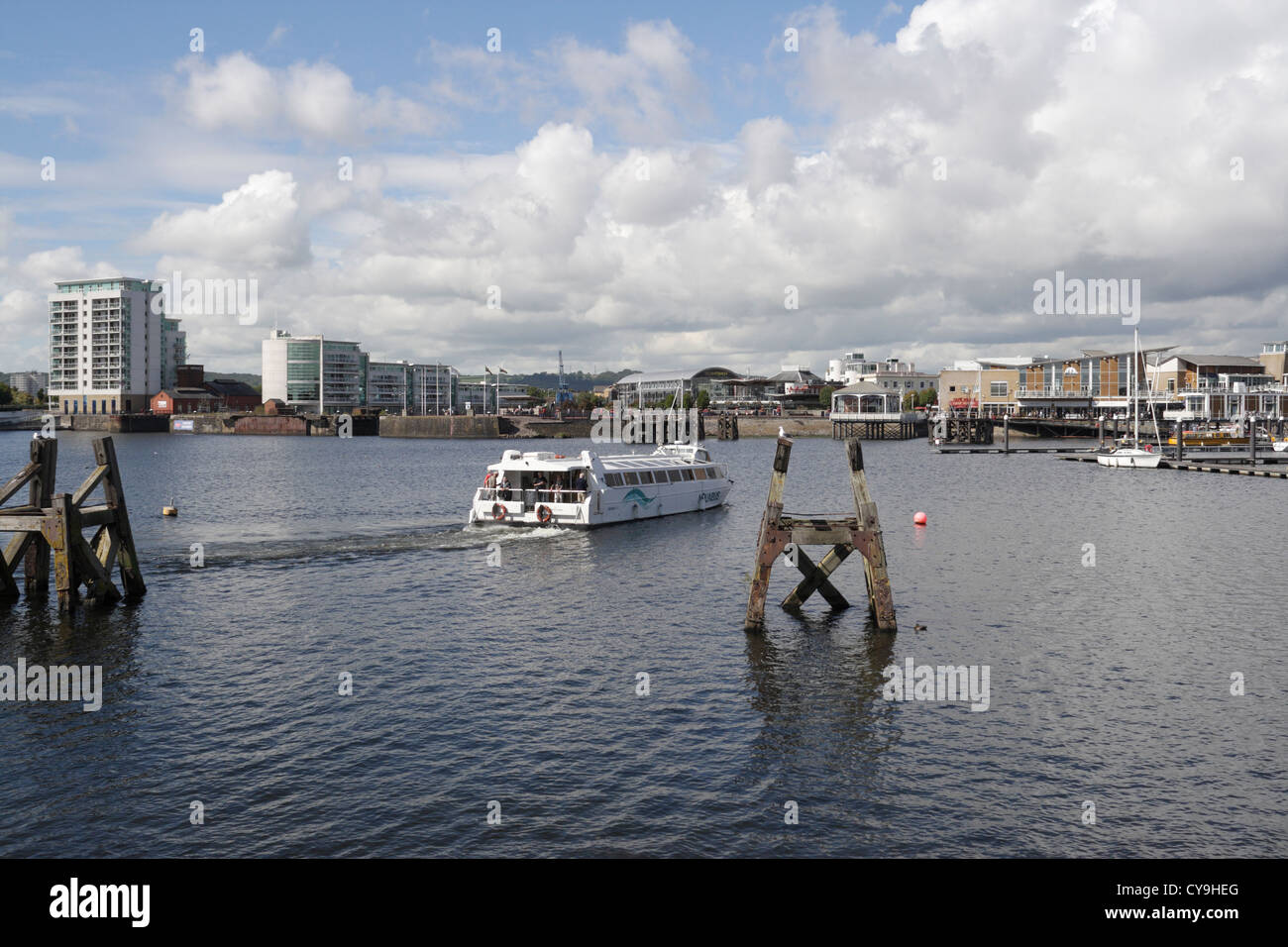 Waterbus coming to berth in Cardiff Bay, Wales UK. View of barrage and ...
