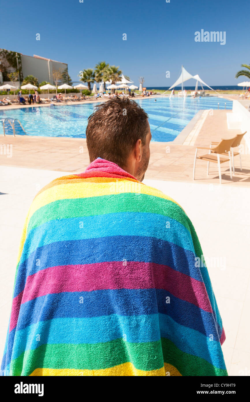 A man sat around a swimming pool at a holiday complex in Myrina on ...