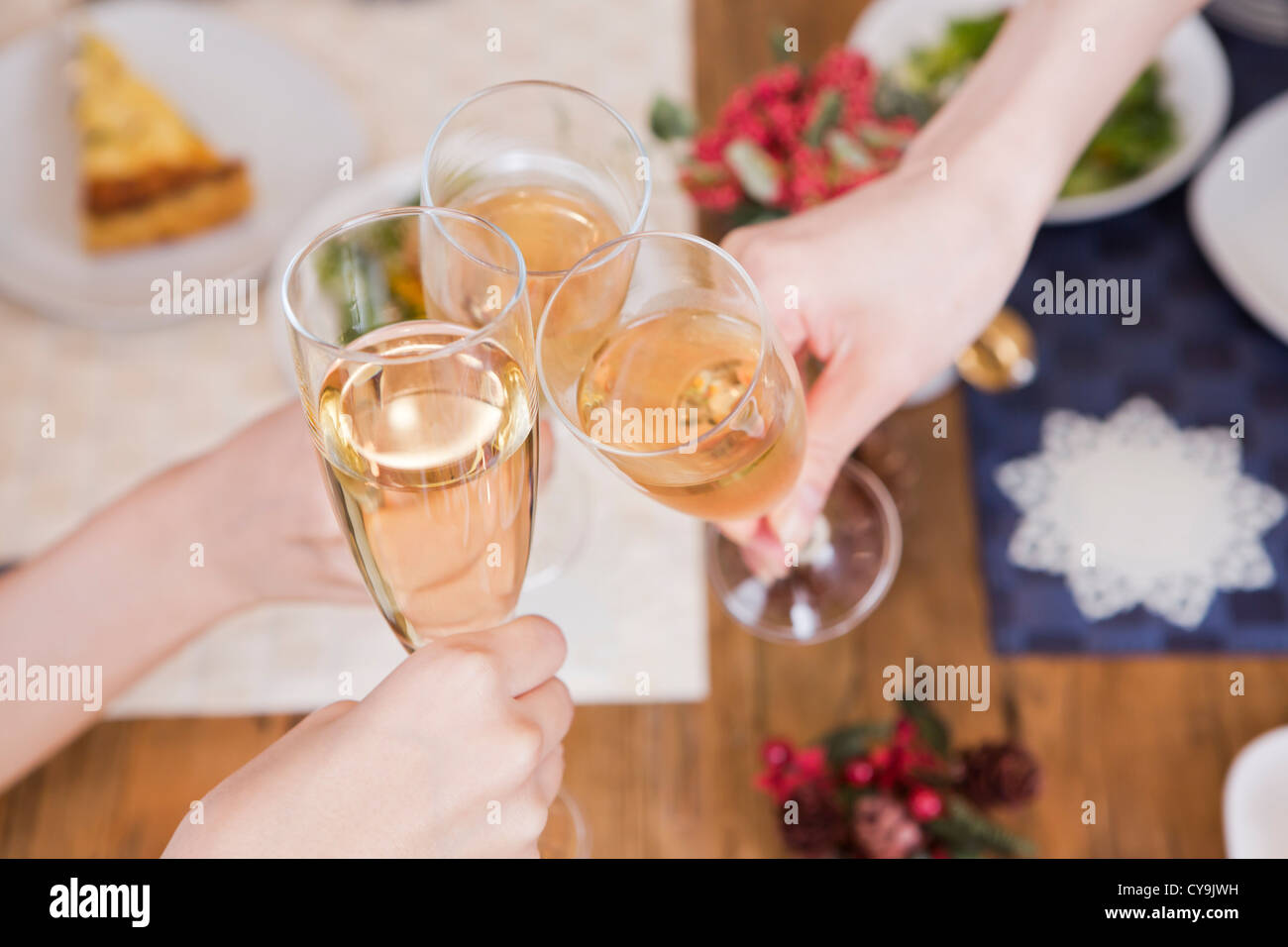 Three People Toasting with Champagne Flute Stock Photo - Alamy