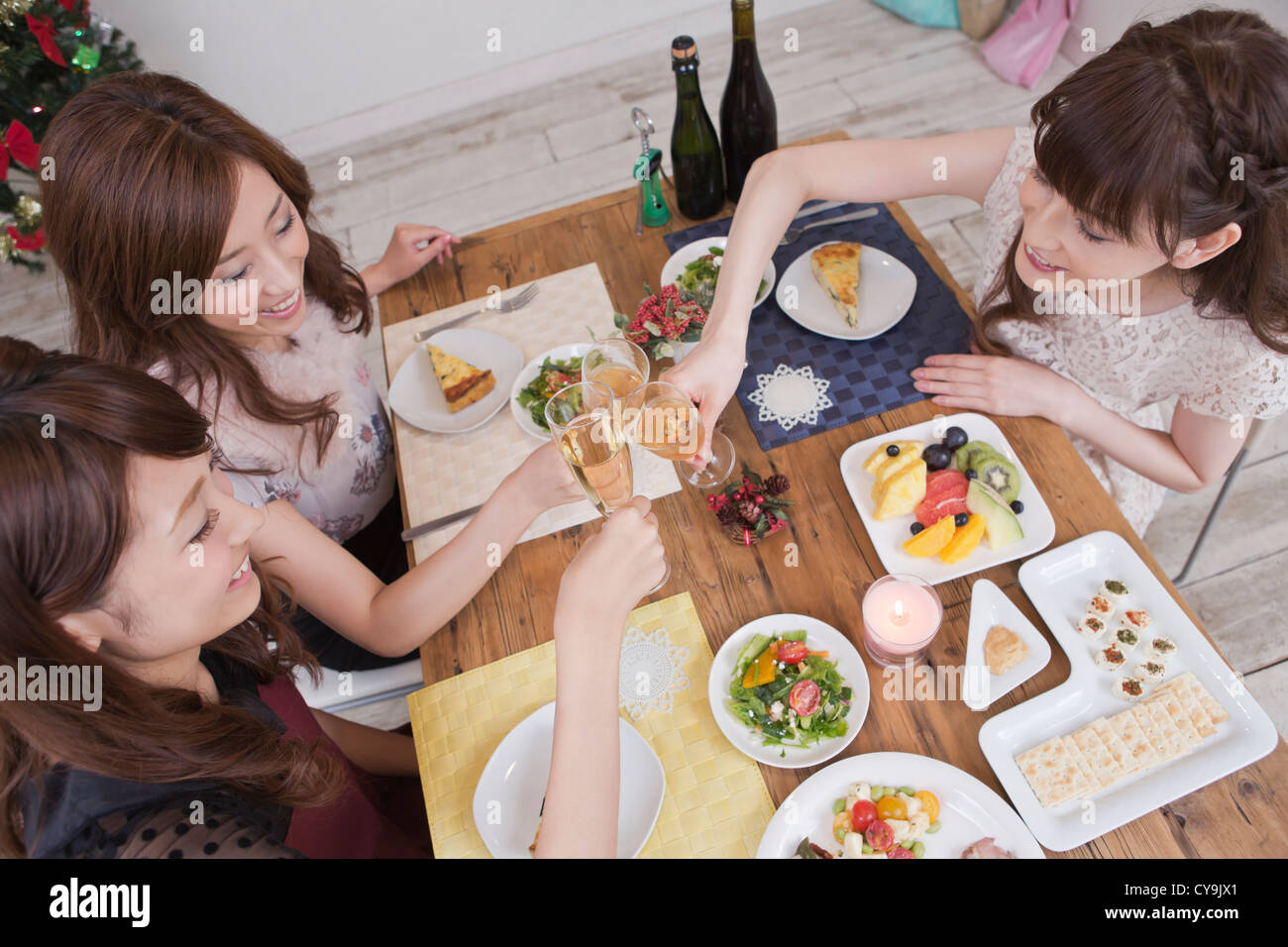 Three Young Women Toasting Stock Photo - Alamy