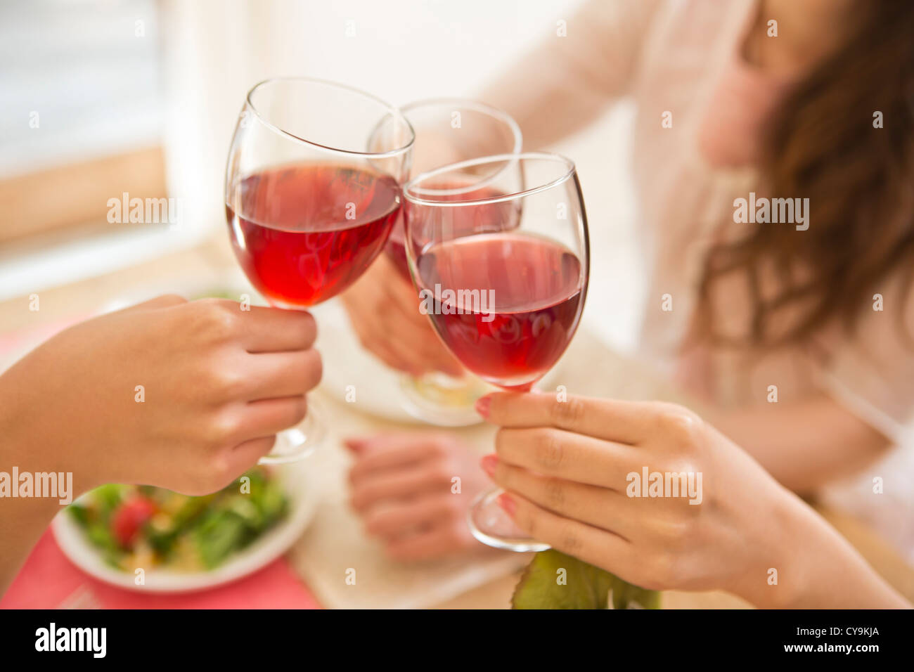 Three People Toasting with Wine Stock Photo - Alamy
