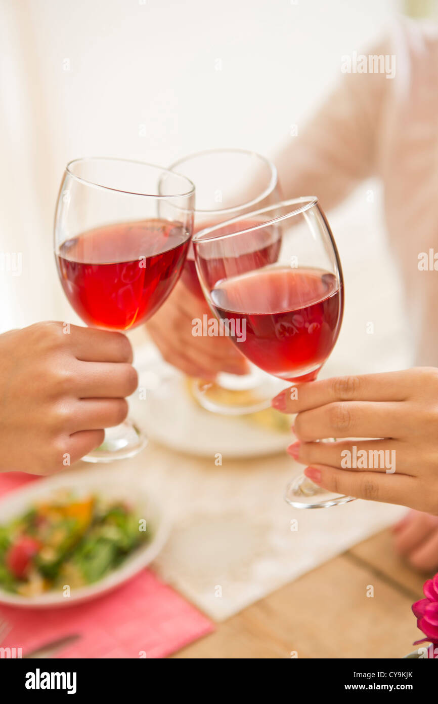 Three People Toasting with Wine Stock Photo - Alamy