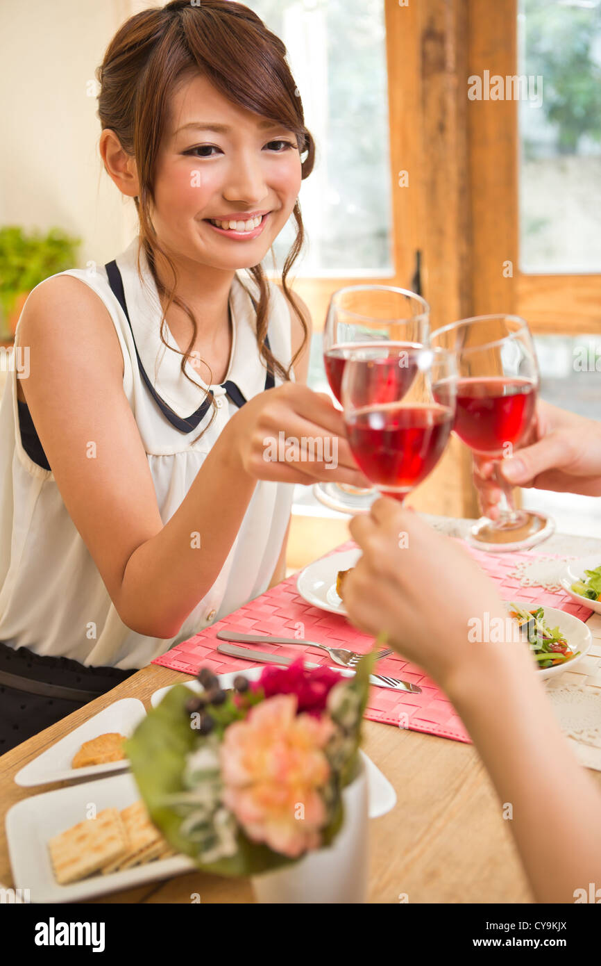 Three Young Women Toasting with Wine Stock Photo - Alamy