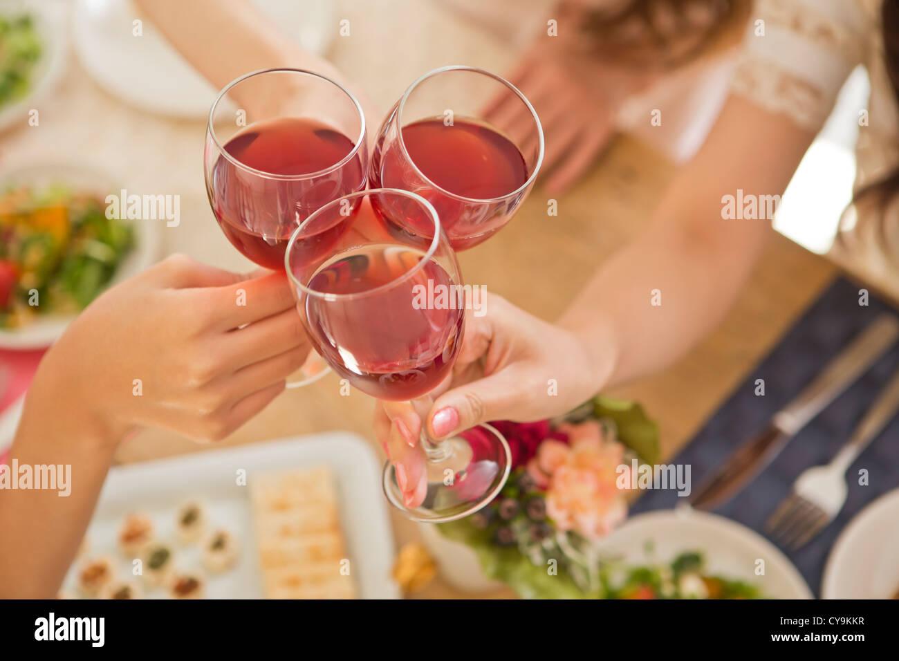 Three People Toasting with Wine Stock Photo - Alamy