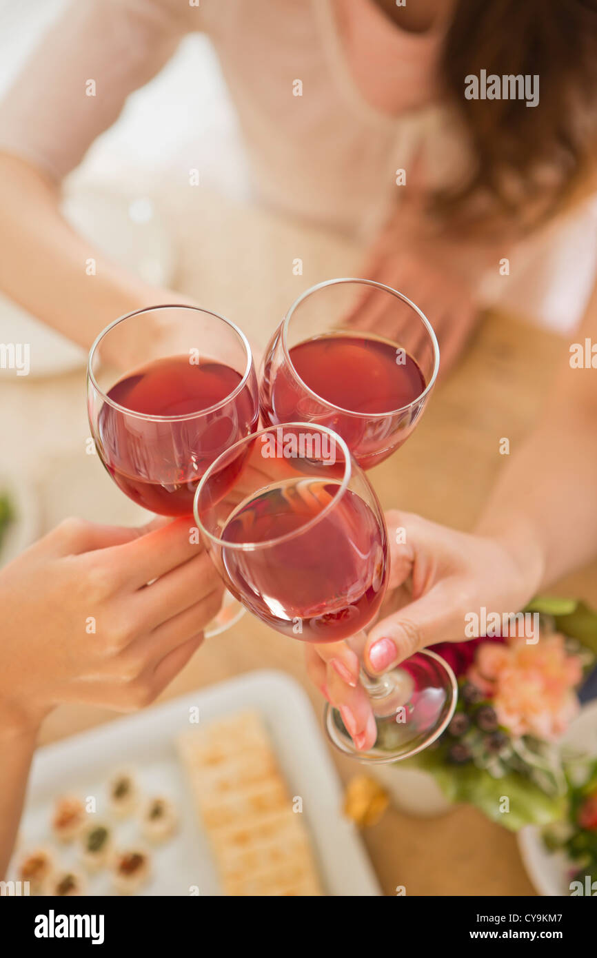 Three People Toasting with Wine Stock Photo - Alamy