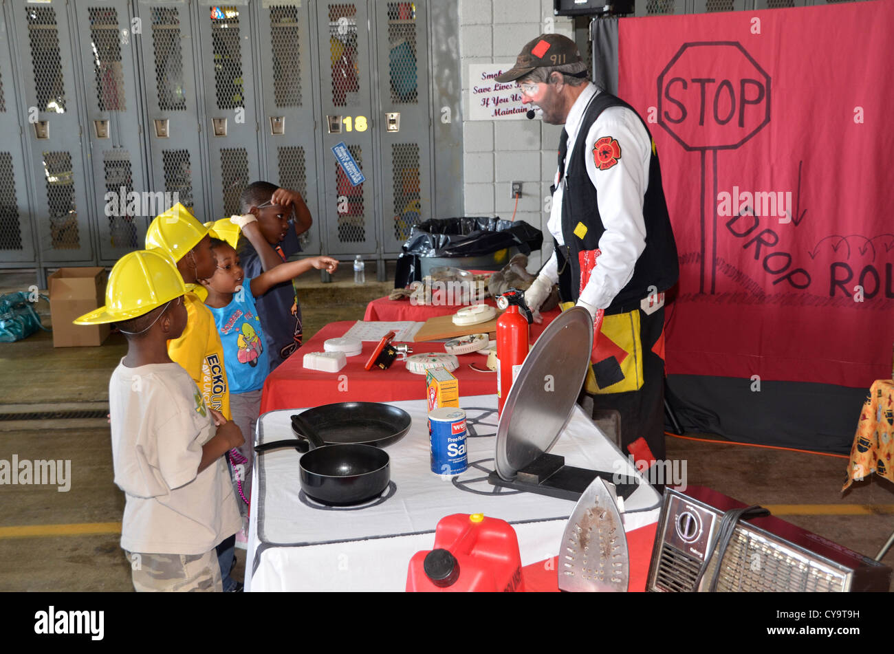 A fire department clown gives a speech to children on preventing fires ...